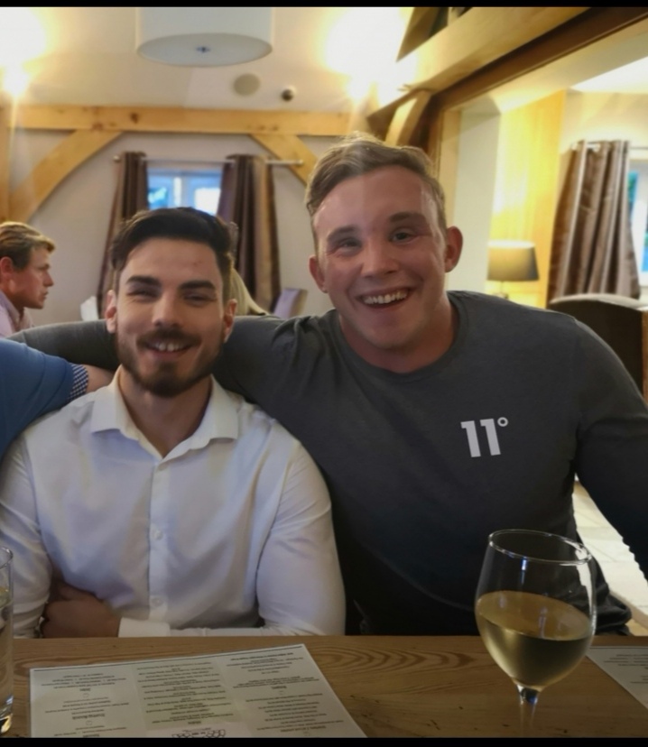 Josh M and Josh W at a restaurant laughing - Goalball UK